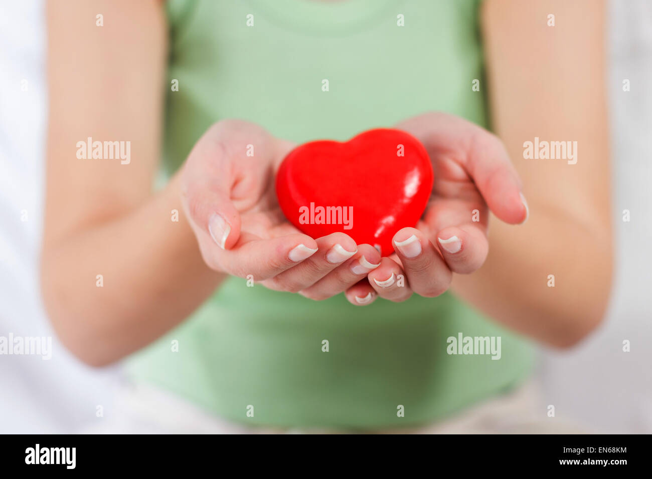 Health Care Love Support Red Heart in female hands Stock Photo - Alamy