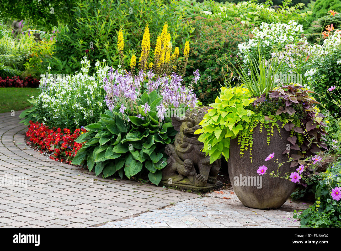 Detail of a beautiful summer garden with an interlocking stone walkway ...