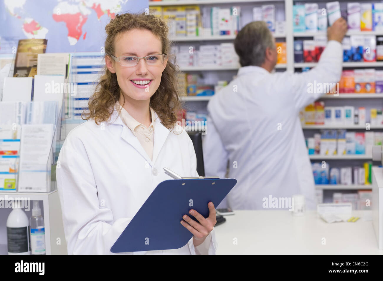 Pharmacist writing on clipboard Stock Photo - Alamy