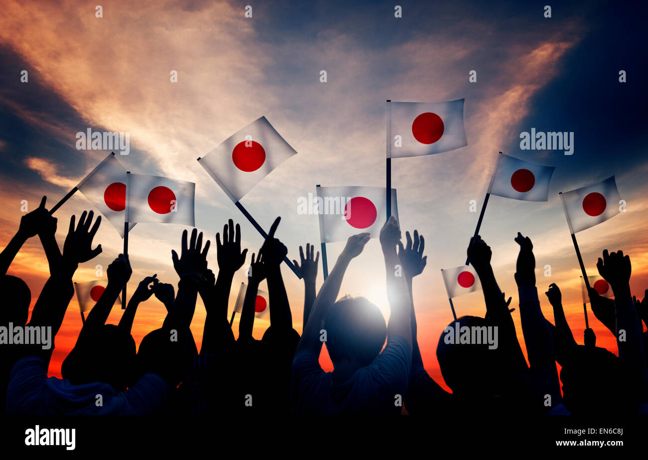 Silhouettes of People Holding the Flag of Japan Stock Photo - Alamy