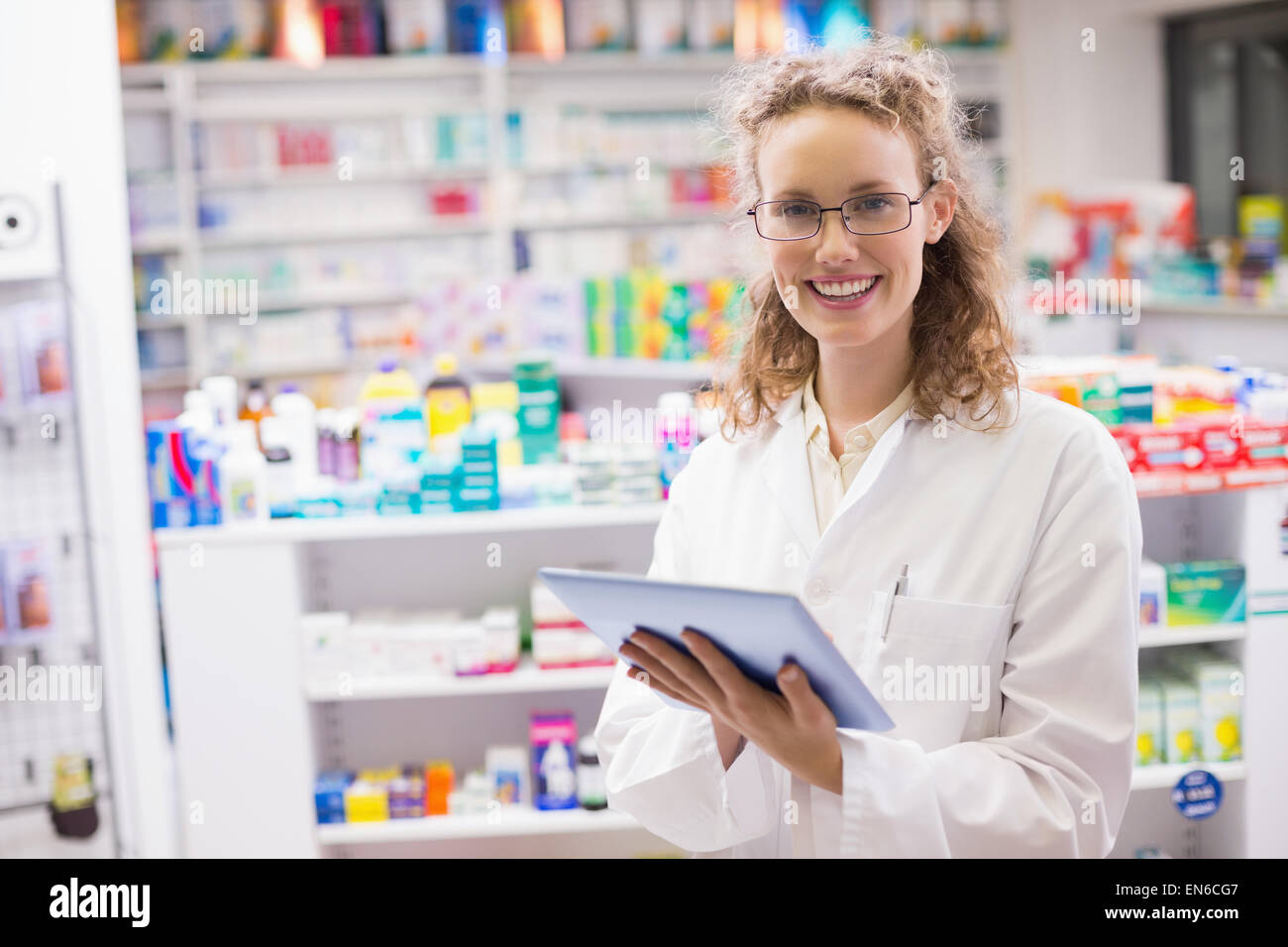 Pharmacist using tablet pc Stock Photo - Alamy