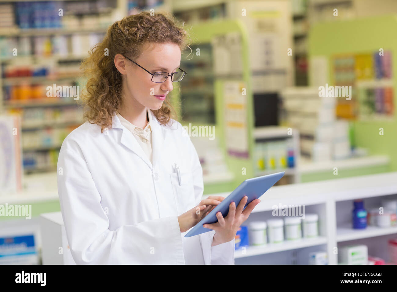 Pharmacist using tablet pc Stock Photo - Alamy