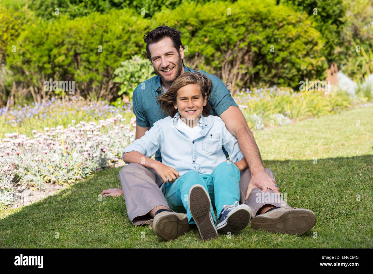 Father and son smiling at camera Stock Photo - Alamy