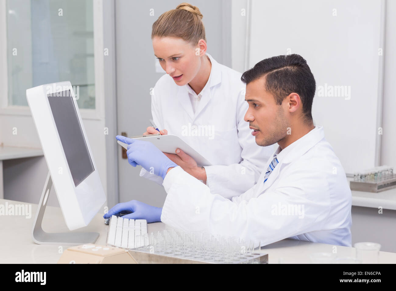 Scientists looking at computer Stock Photo - Alamy