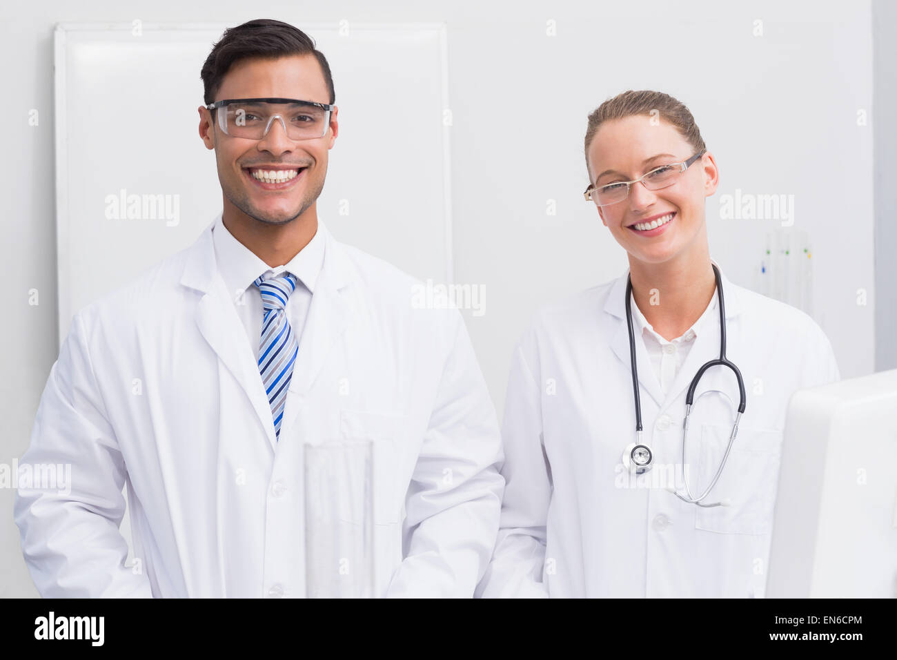 Happy scientists smiling at camera Stock Photo - Alamy