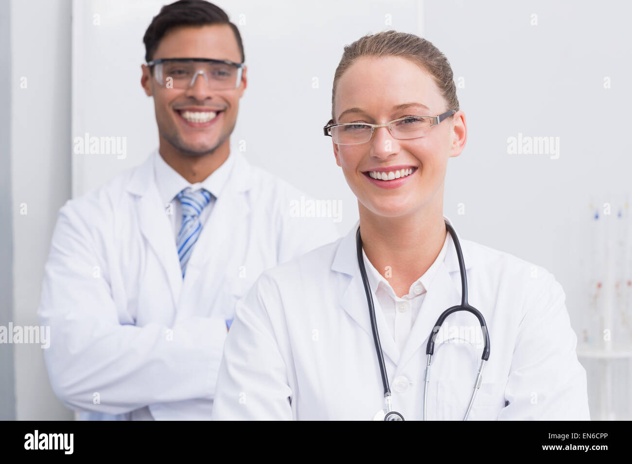 Happy scientists smiling at camera with arms crossed Stock Photo - Alamy