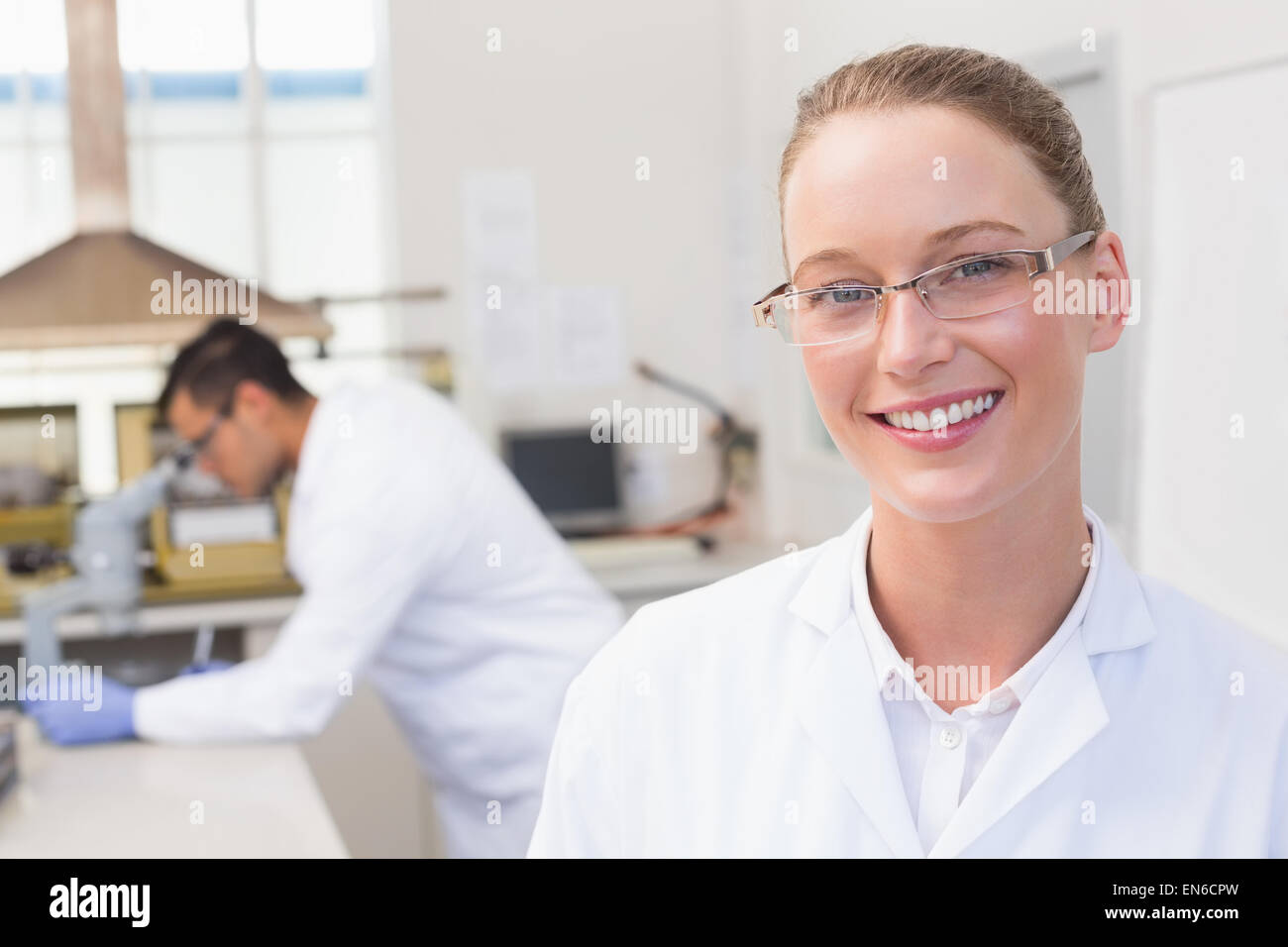 Happy scientist smiling at camera Stock Photo - Alamy