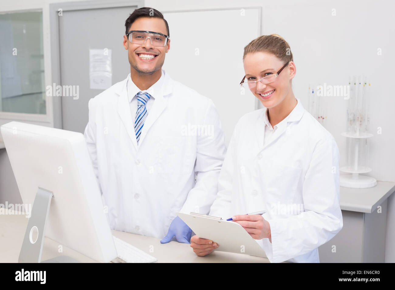Happy scientists smiling at camera Stock Photo - Alamy
