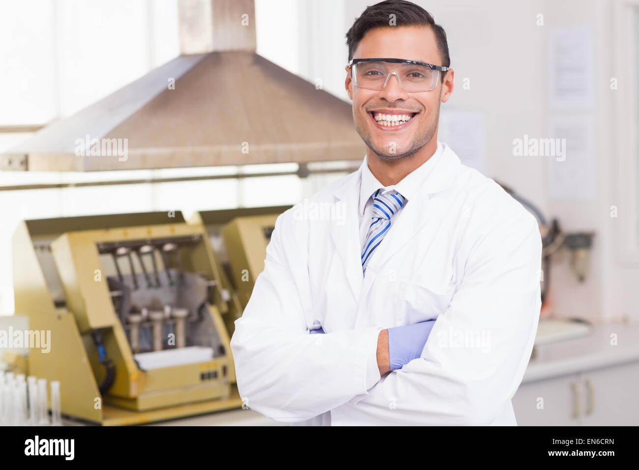 Happy scientist smiling at camera with arms crossed Stock Photo - Alamy