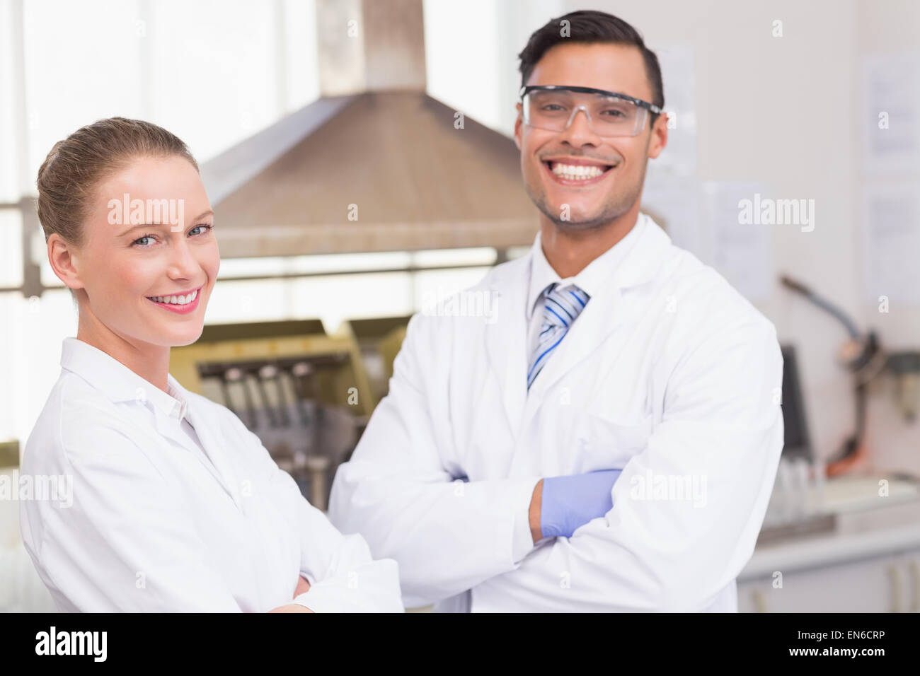 Happy scientists smiling at camera with arms crossed Stock Photo - Alamy