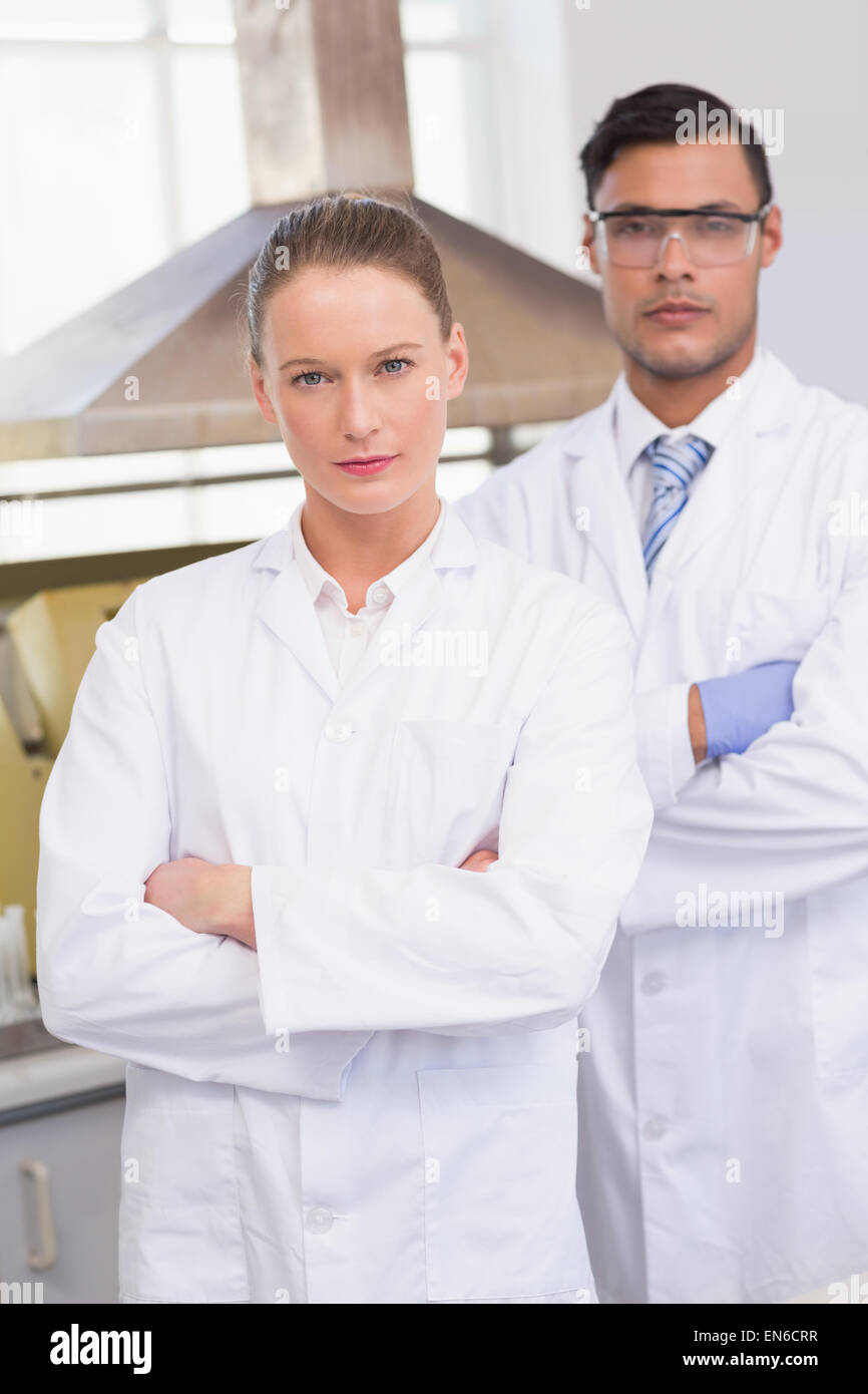 Serious scientists looking at camera with arms crossed Stock Photo - Alamy