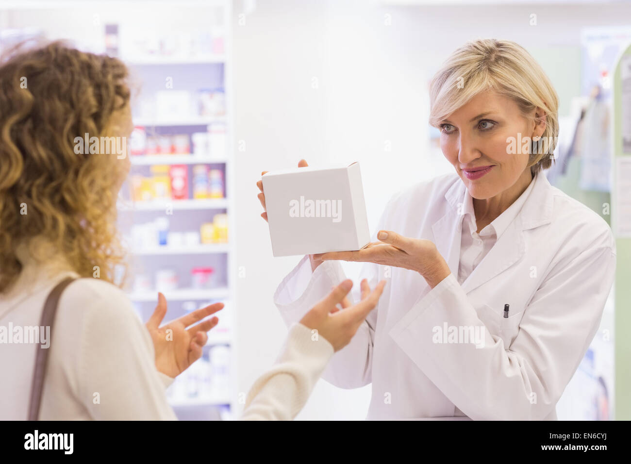 Pharmacist holding prescription smiling talking hi-res stock ...