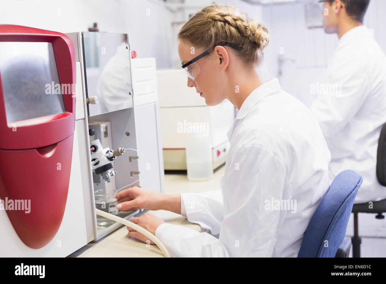 Concentrated scientists working with medical machine Stock Photo - Alamy