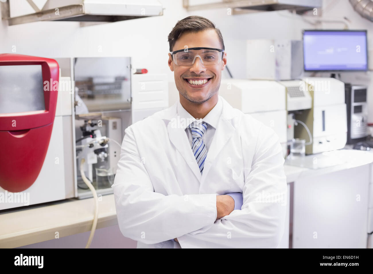 Smiling scientist looking at camera arms crossed Stock Photo - Alamy