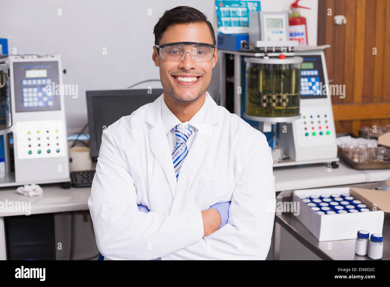 Happy scientist smiling at camera with arms crossed Stock Photo - Alamy