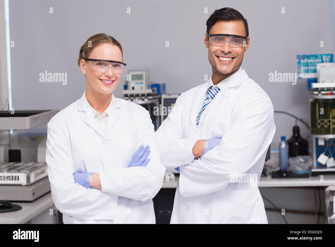 Smiling scientists looking at camera arms crossed Stock Photo - Alamy