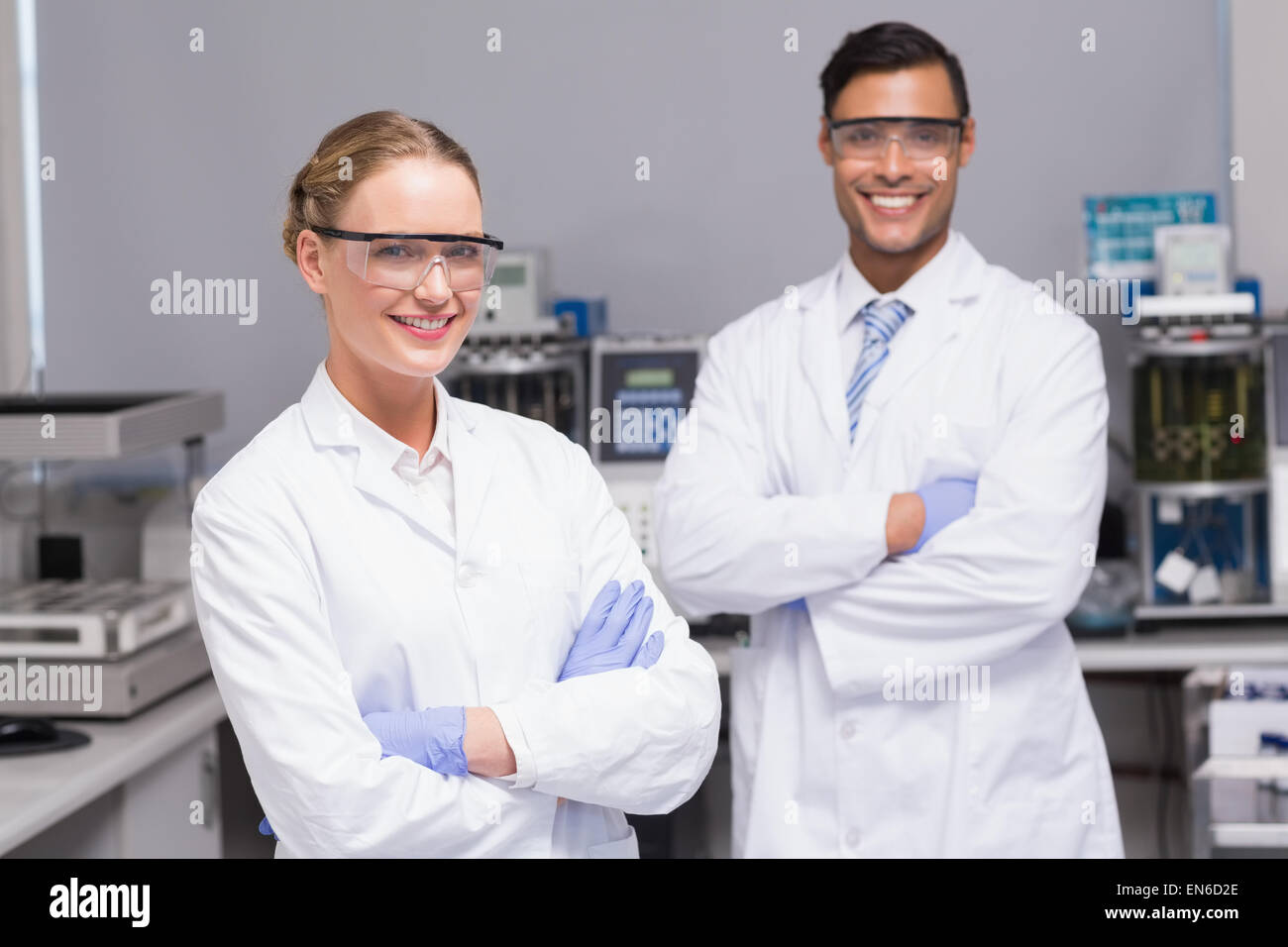 Smiling scientists looking at camera arms crossed Stock Photo - Alamy