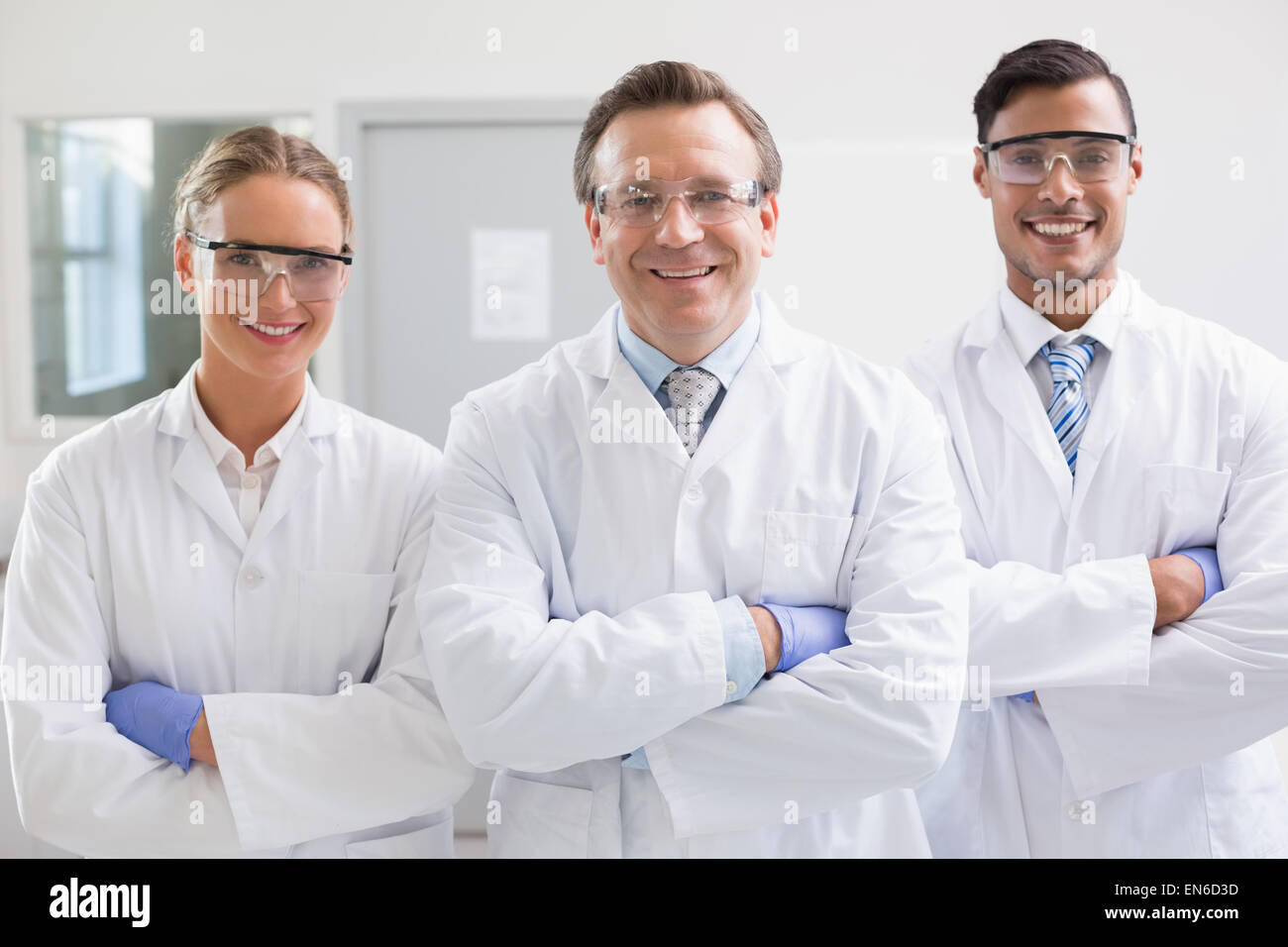 Smiling scientists looking at camera arms crossed Stock Photo - Alamy