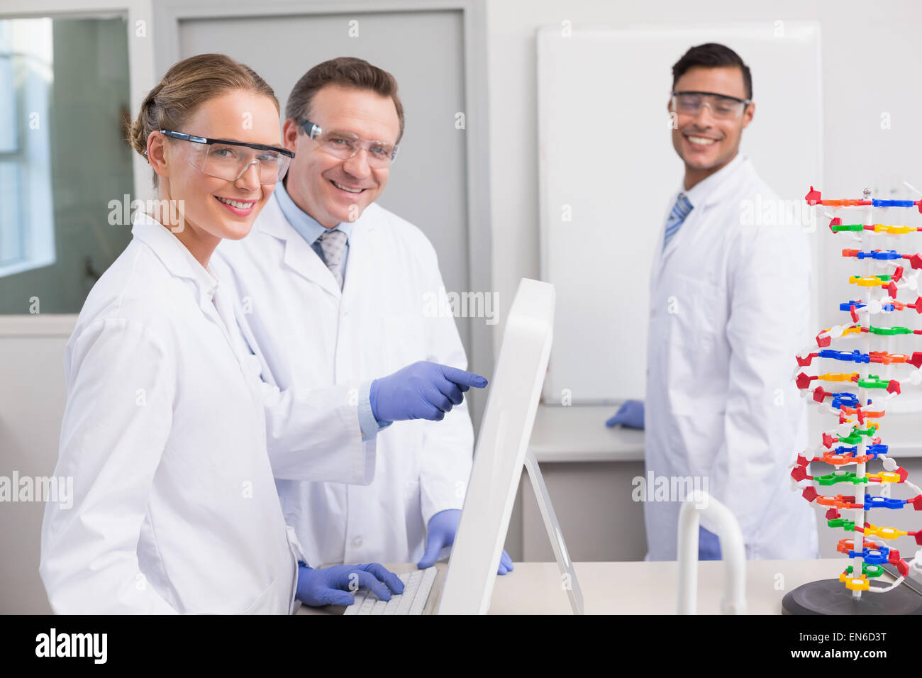 Smiling scientist working with computer Stock Photo - Alamy