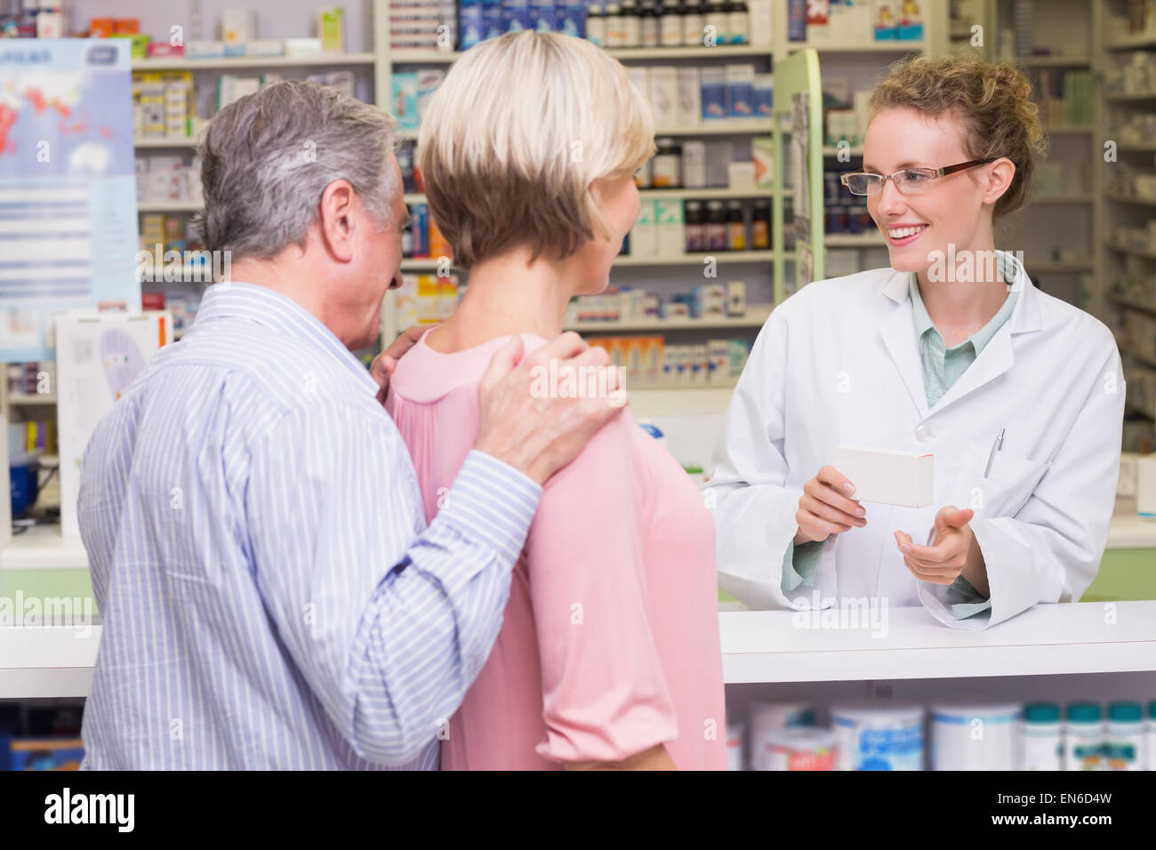Pharmacist explaining something to a customer Stock Photo - Alamy