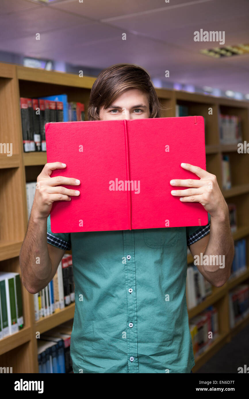 Young man with book covering his face hi-res stock photography and ...