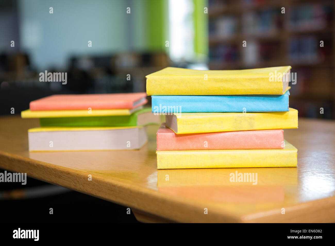 Stack of books in library Stock Photo - Alamy