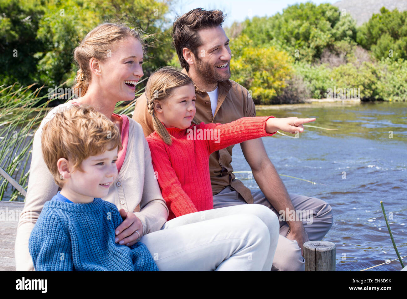 Happy family at a lake Stock Photo - Alamy