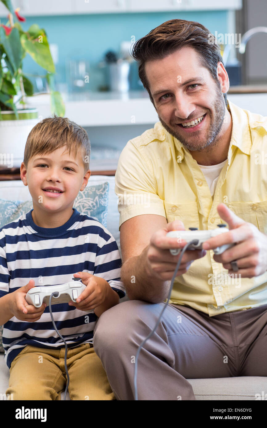 Father and son playing video games together Stock Photo - Alamy