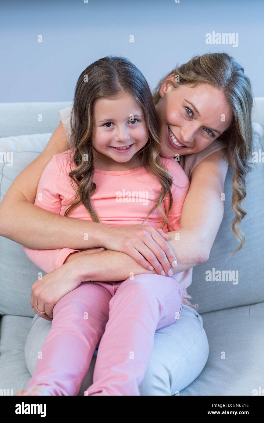 Father and daughter hugging on couch Stock Photo - Alamy