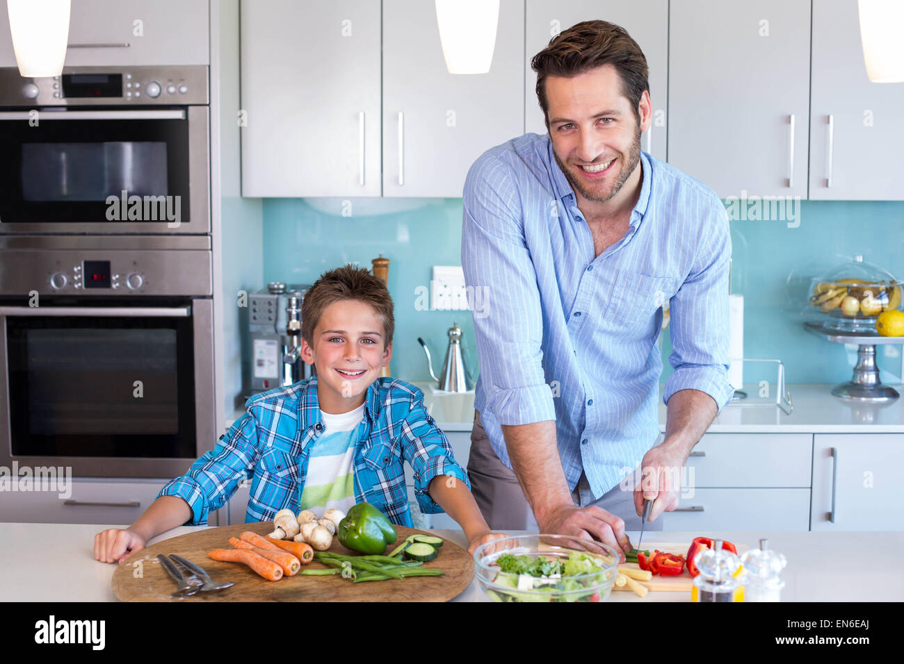 Happy family preparing lunch together Stock Photo - Alamy