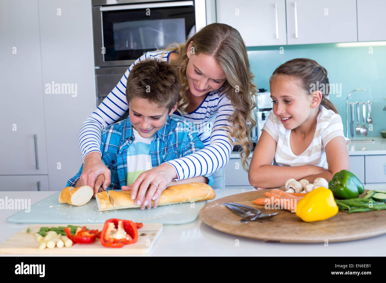 Happy family preparing lunch together Stock Photo - Alamy