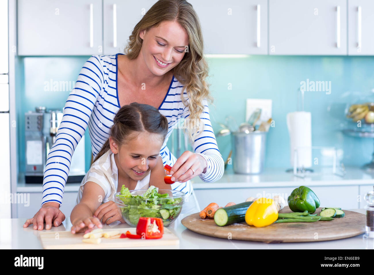 Happy family preparing lunch together Stock Photo - Alamy