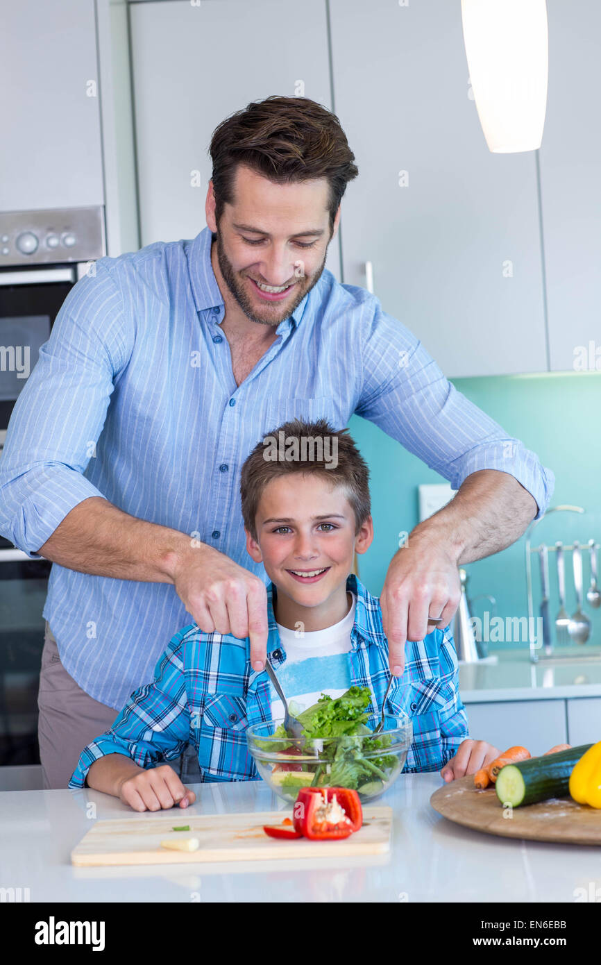 Happy family preparing lunch together Stock Photo - Alamy