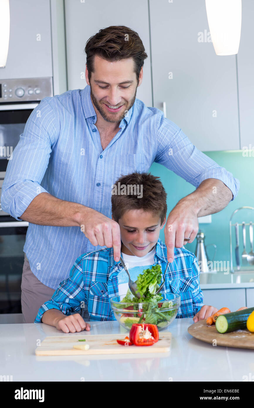 Happy family preparing lunch together Stock Photo - Alamy