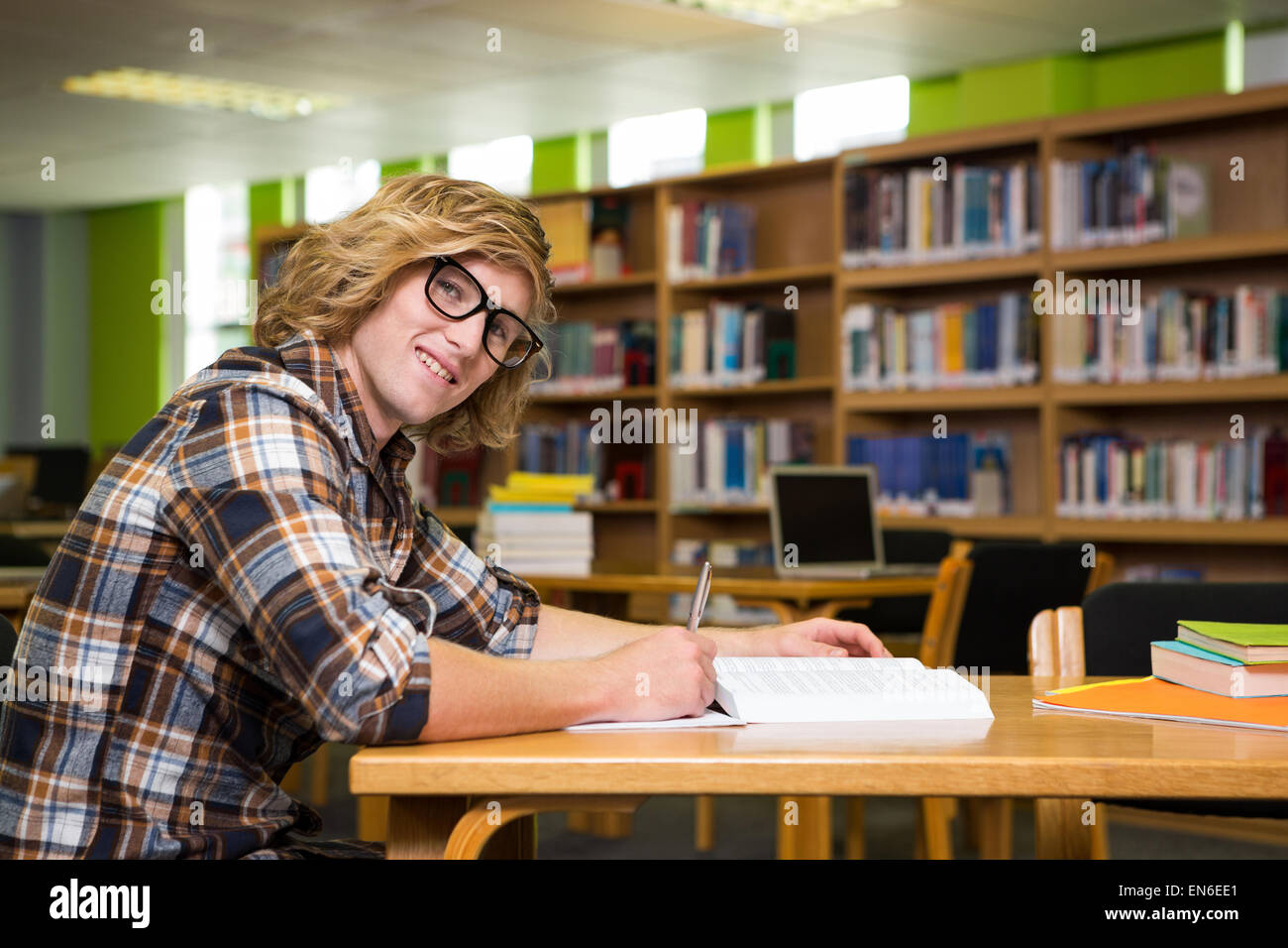 Student studying in the library Stock Photo - Alamy