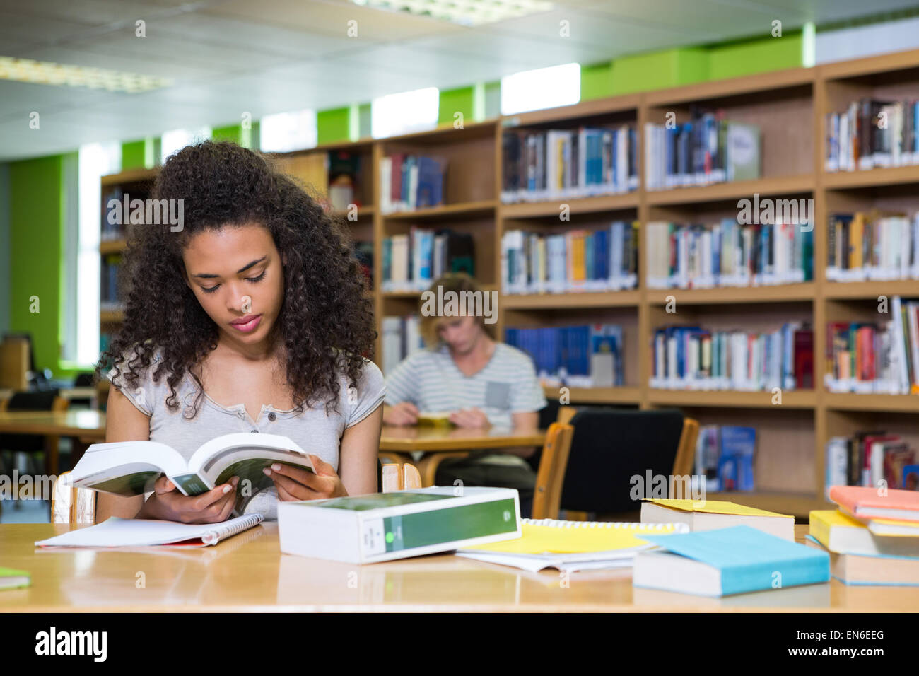 Student studying in the library Stock Photo - Alamy