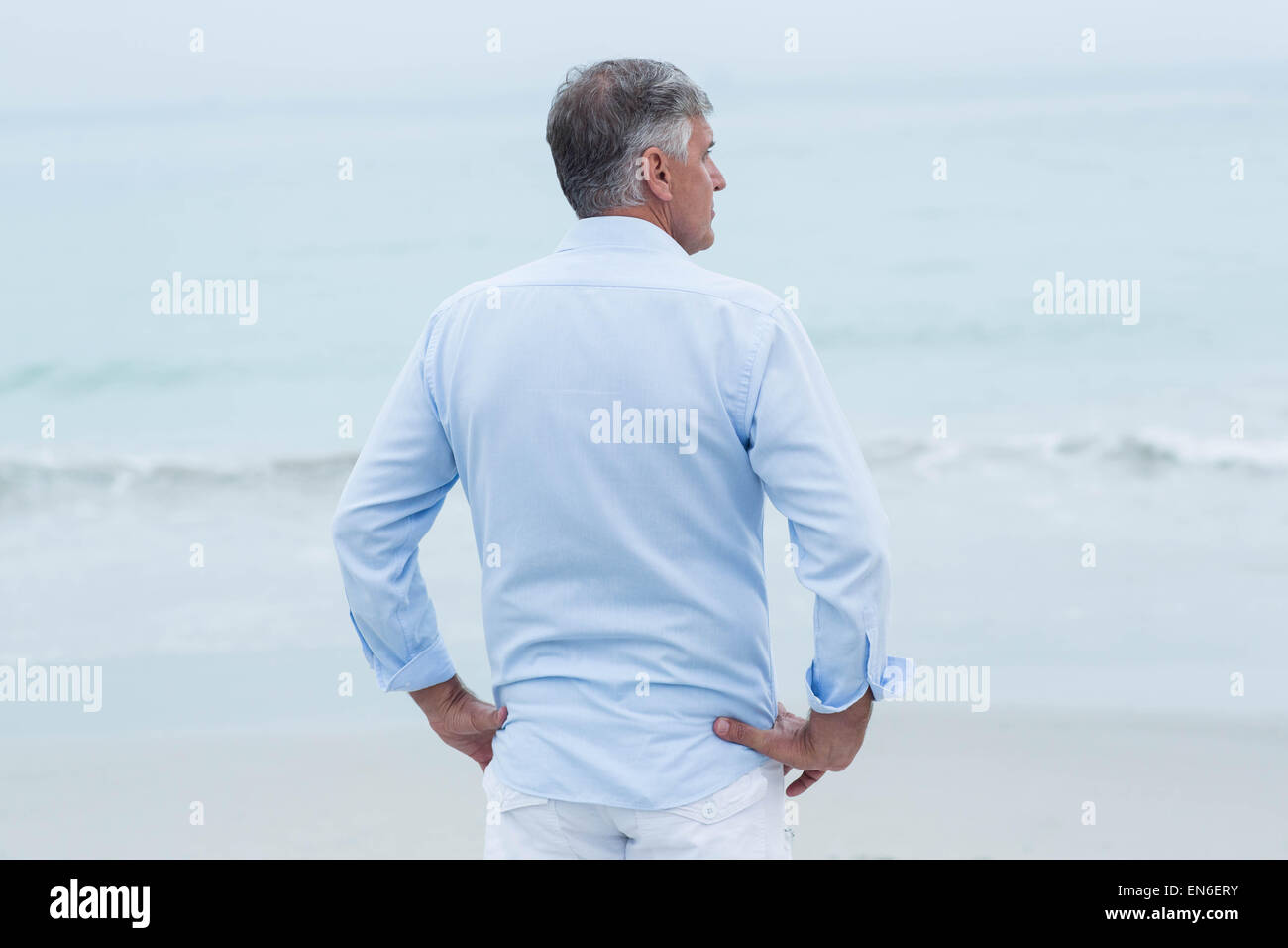 Thoughtful man standing by the sea Stock Photo - Alamy