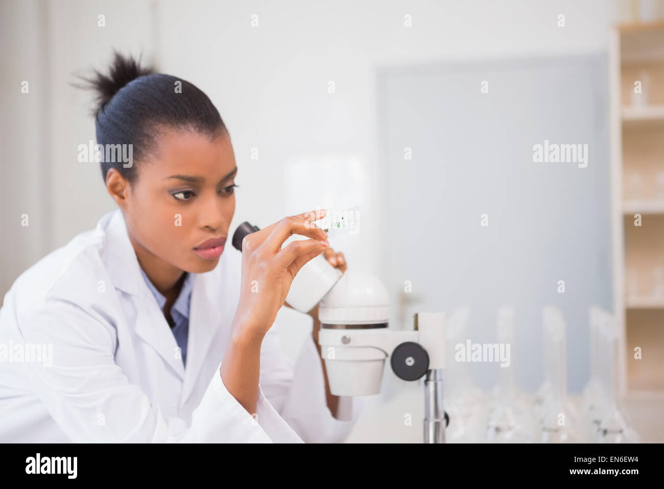 Scientist looking in microscope Stock Photo - Alamy
