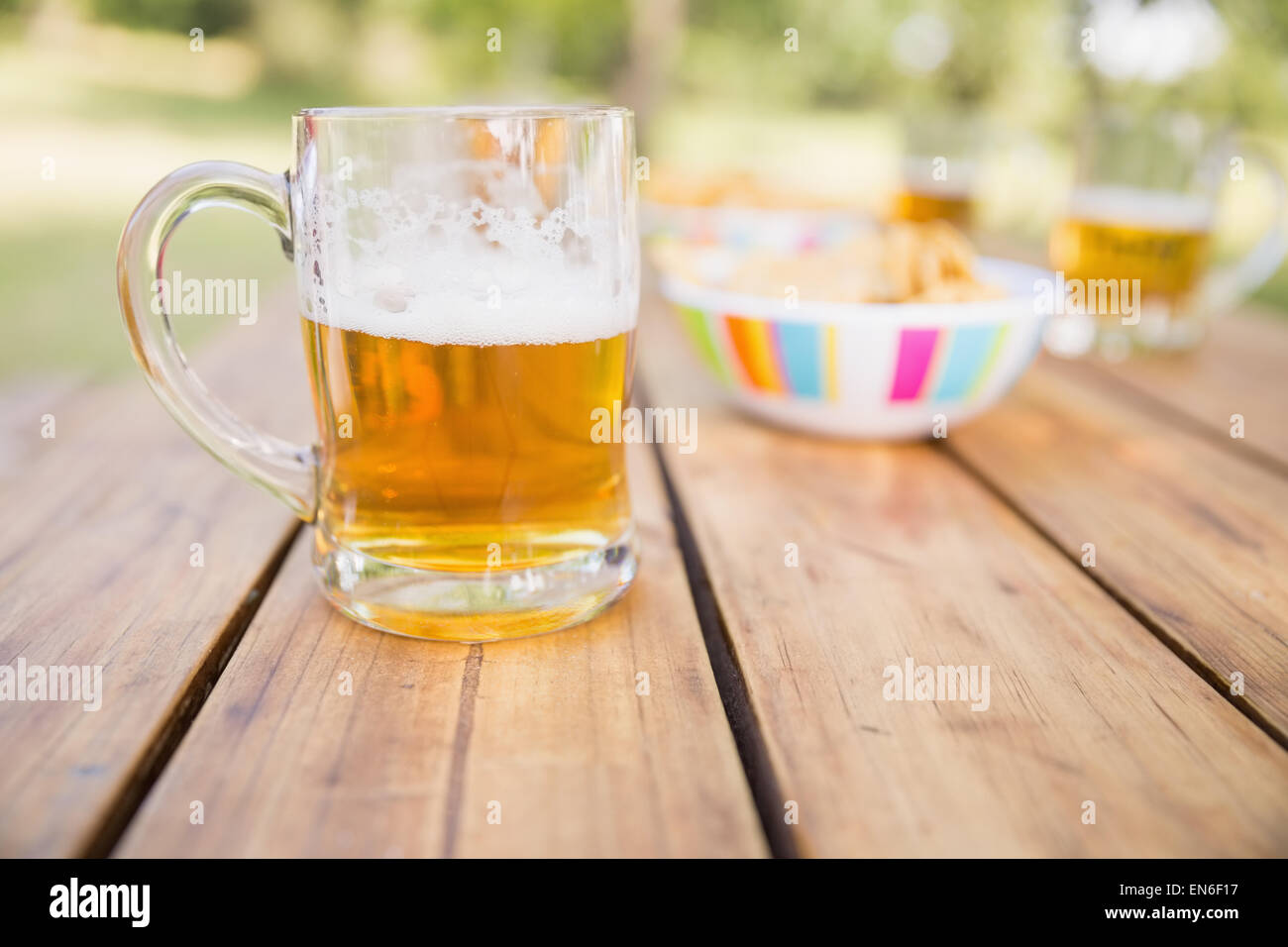 Beer and snacks on picnic table Stock Photo - Alamy