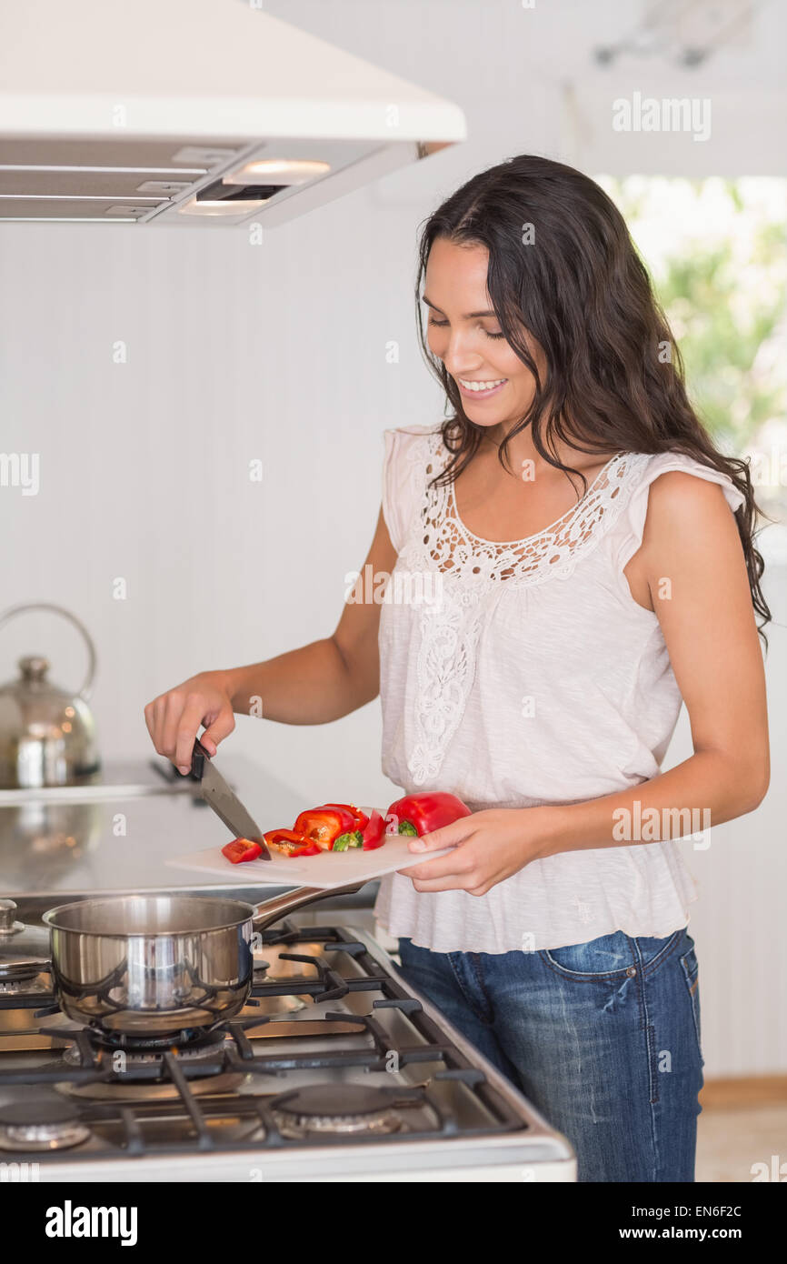 Beautiful brunette woman cooking vegetables hi-res stock photography ...