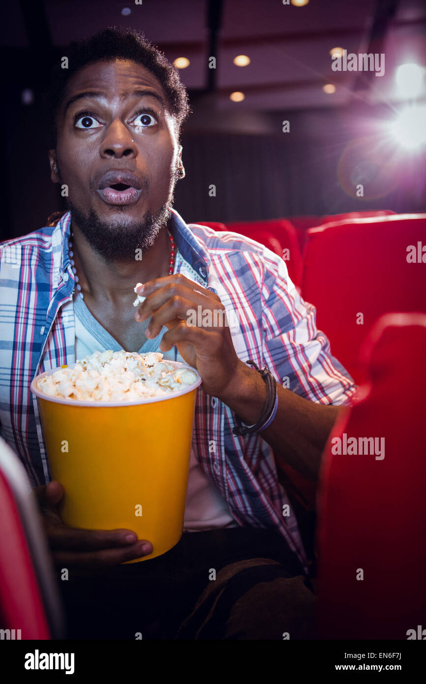 Young man watching a film Stock Photo - Alamy