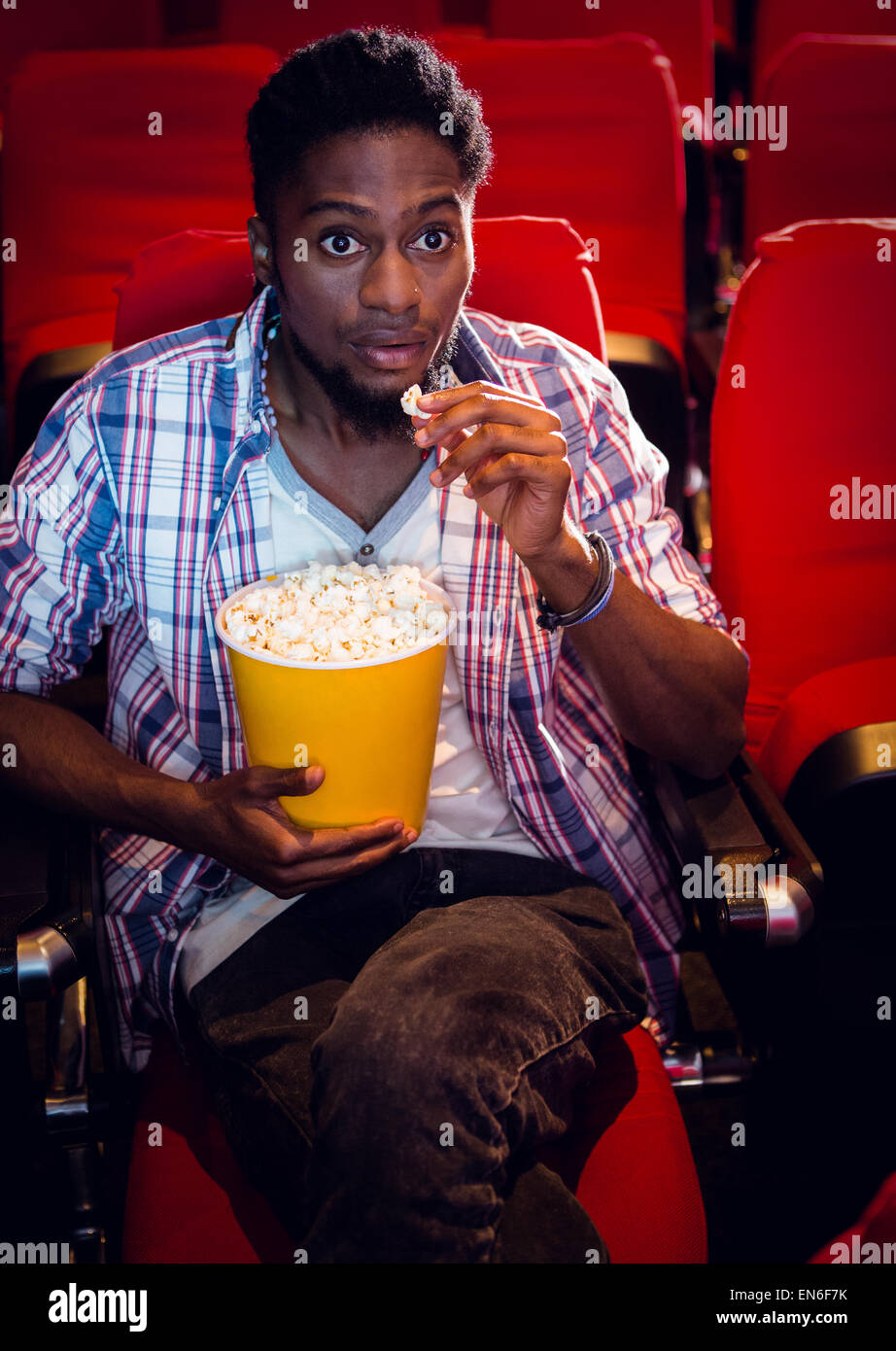 Black man eating popcorn watching hi-res stock photography and images - Alamy