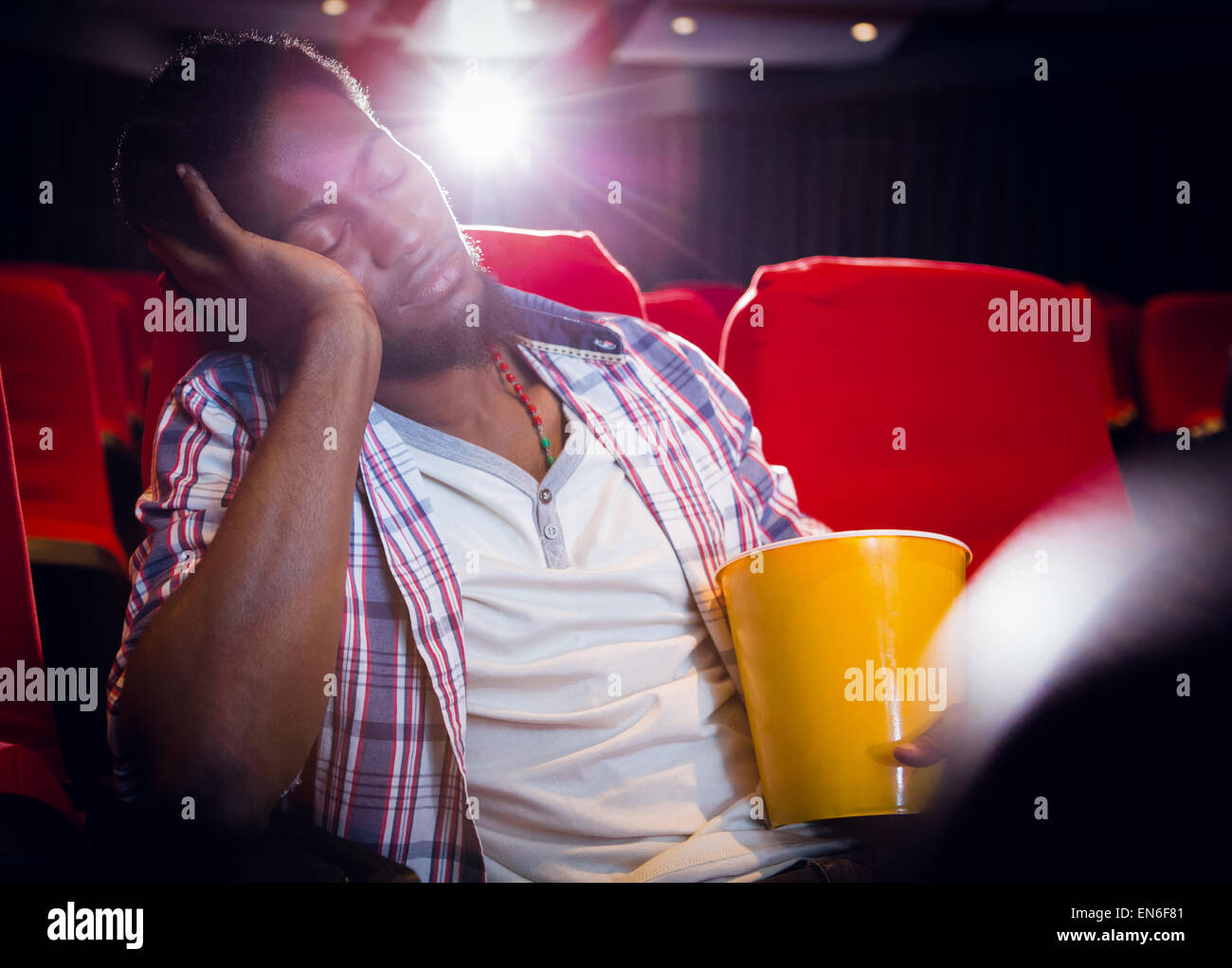 Young man sleeping in chair Stock Photo - Alamy