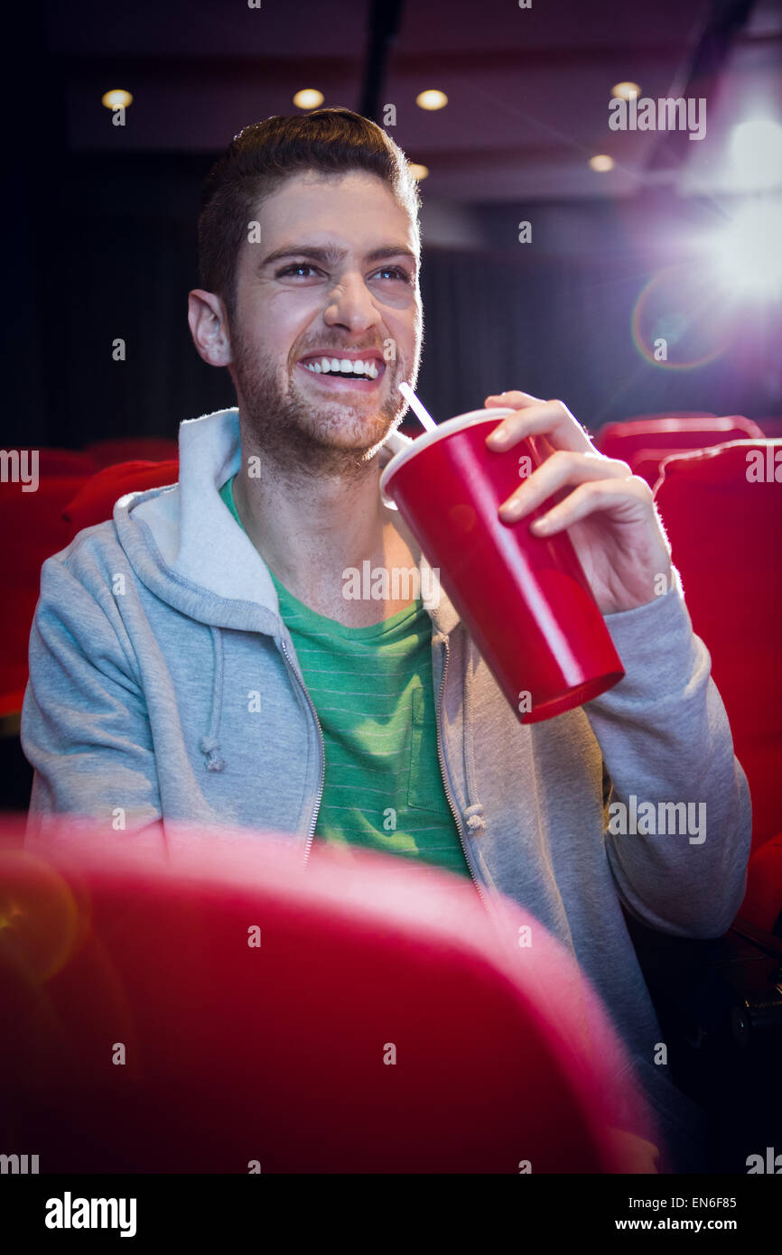 Young man watching a film Stock Photo - Alamy