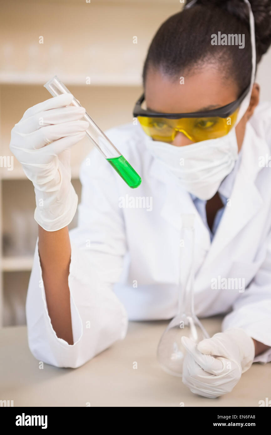 Concentrated scientist analyzing test tube Stock Photo - Alamy
