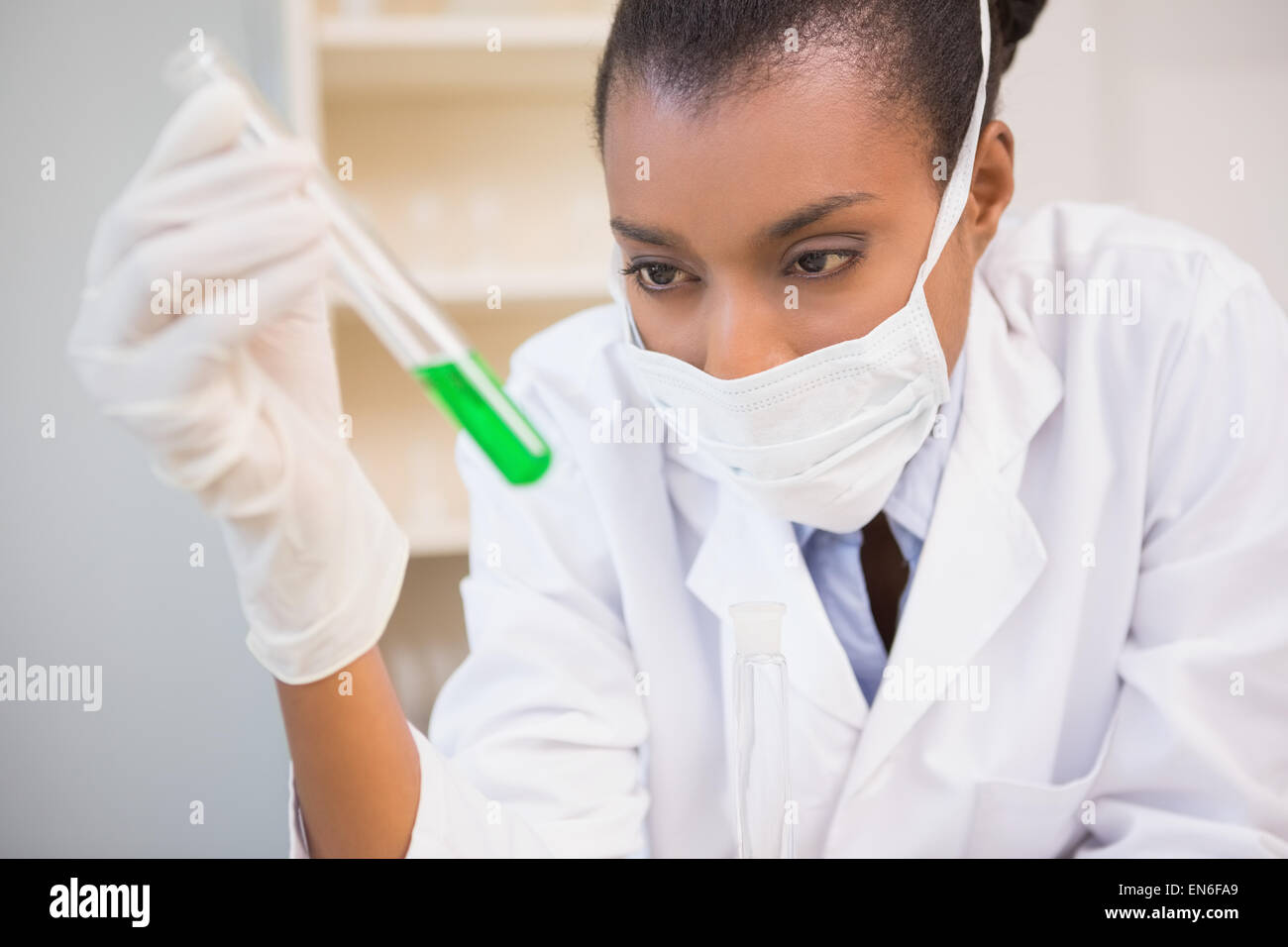 Concentrated scientist analyzing test tube Stock Photo - Alamy