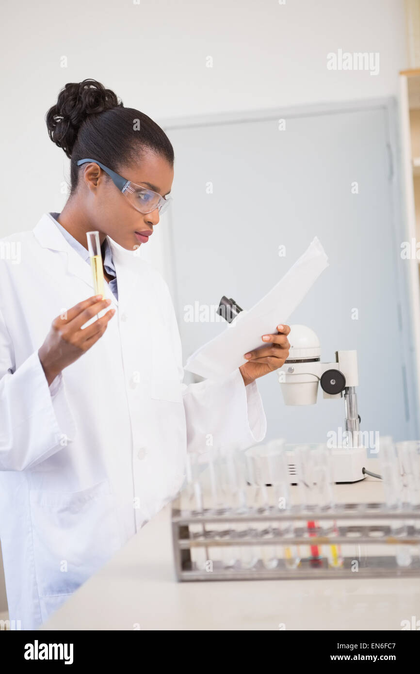 Scientist reading paper Stock Photo - Alamy