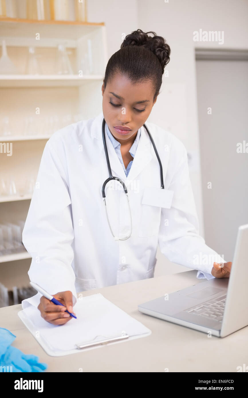 Woman scientist writing notes hi-res stock photography and images - Alamy