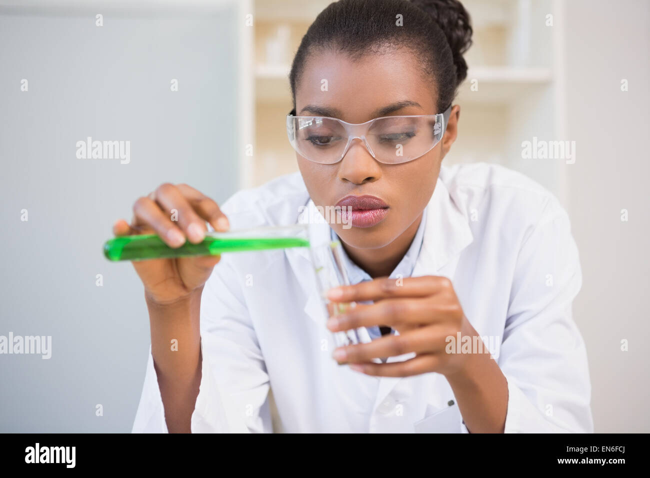 Concentrated scientist doing scientific experiment Stock Photo - Alamy