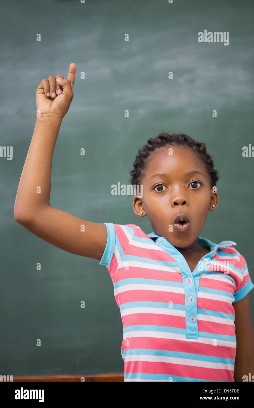 Pupils raising hand in classroom Stock Photo - Alamy